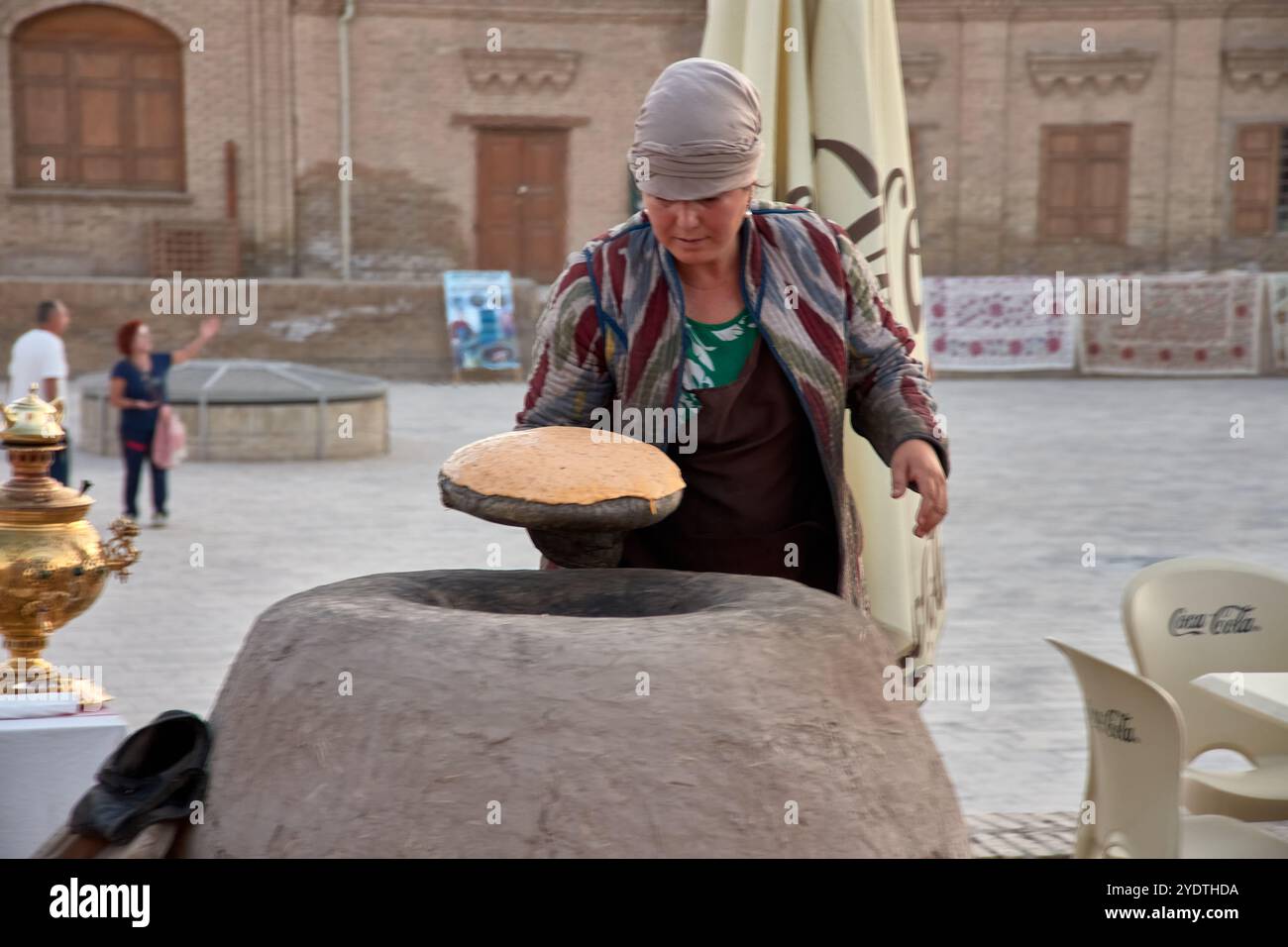 Khiva,Uzbekistan; September,21,2024:an Uzbek woman baking traditional ...