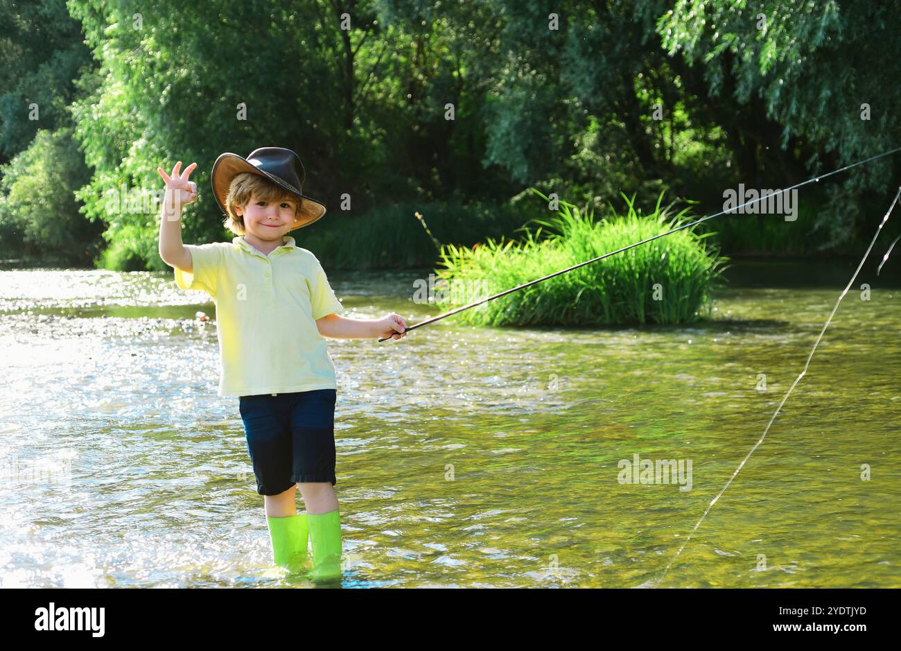 Little kid pulling fishing rod while fishing on weekend. Fisherman ...