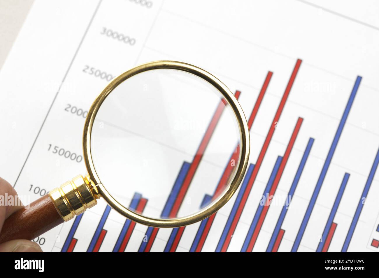 Bar graph and magnifying glass Stock Photo - Alamy