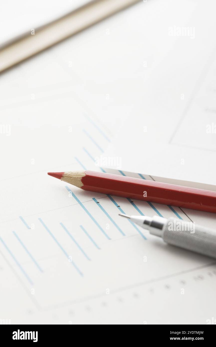 Writing utensils and graph Stock Photo - Alamy
