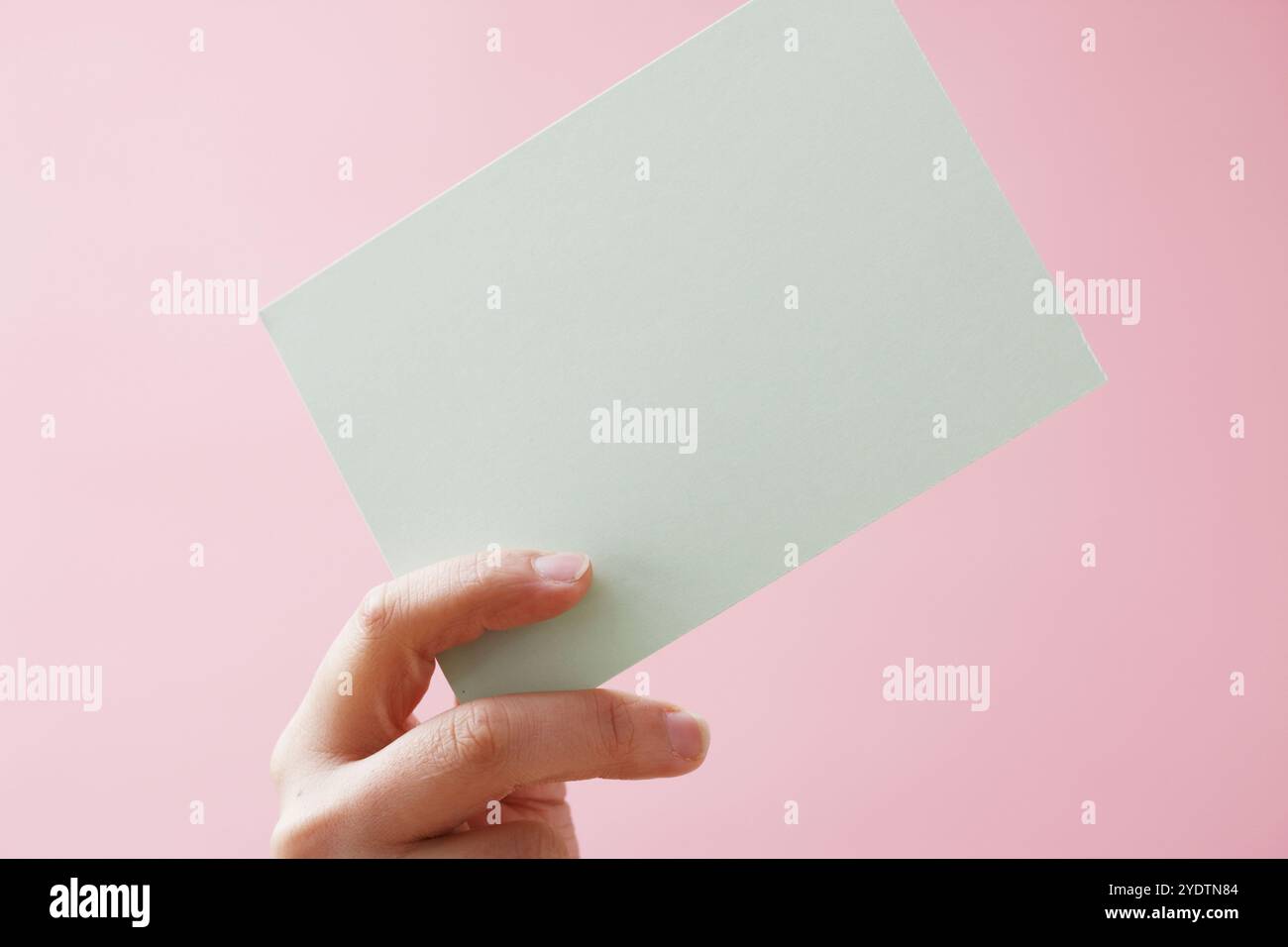 Woman holding blue card Stock Photo - Alamy