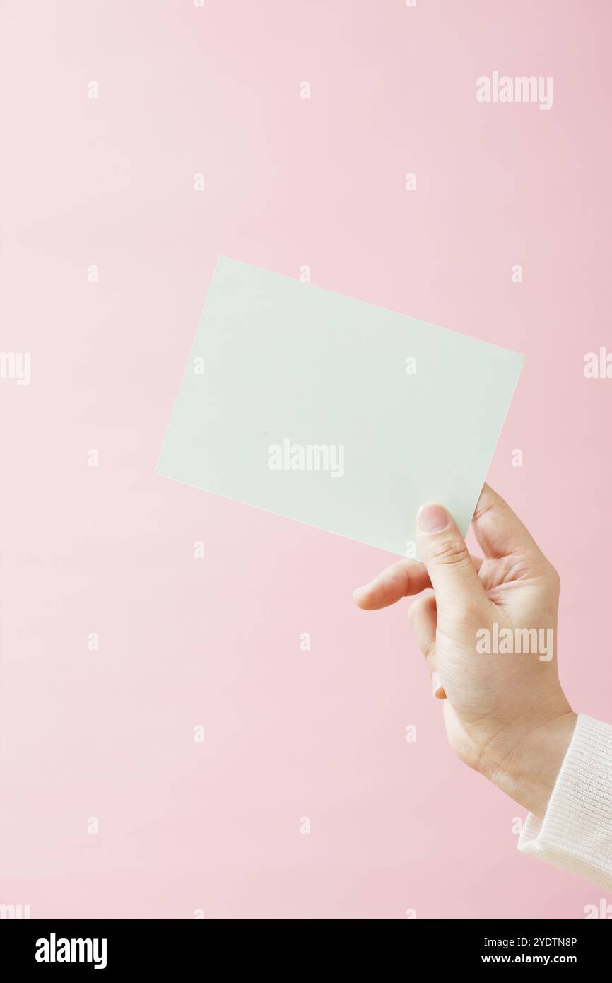 Woman holding blue card Stock Photo - Alamy