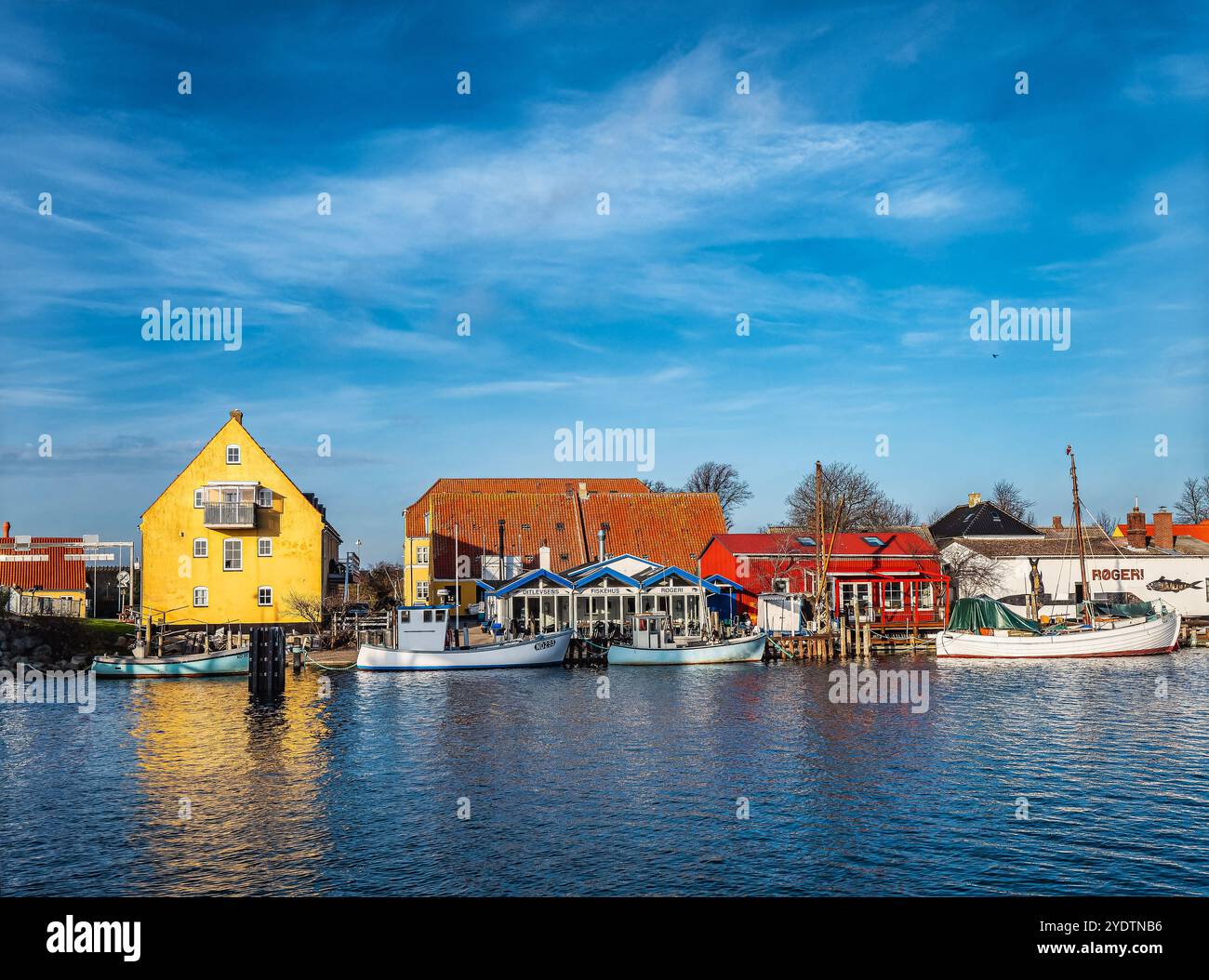 Picturesque coastal village scene Karrebaeksminde, with vibrant yellow ...