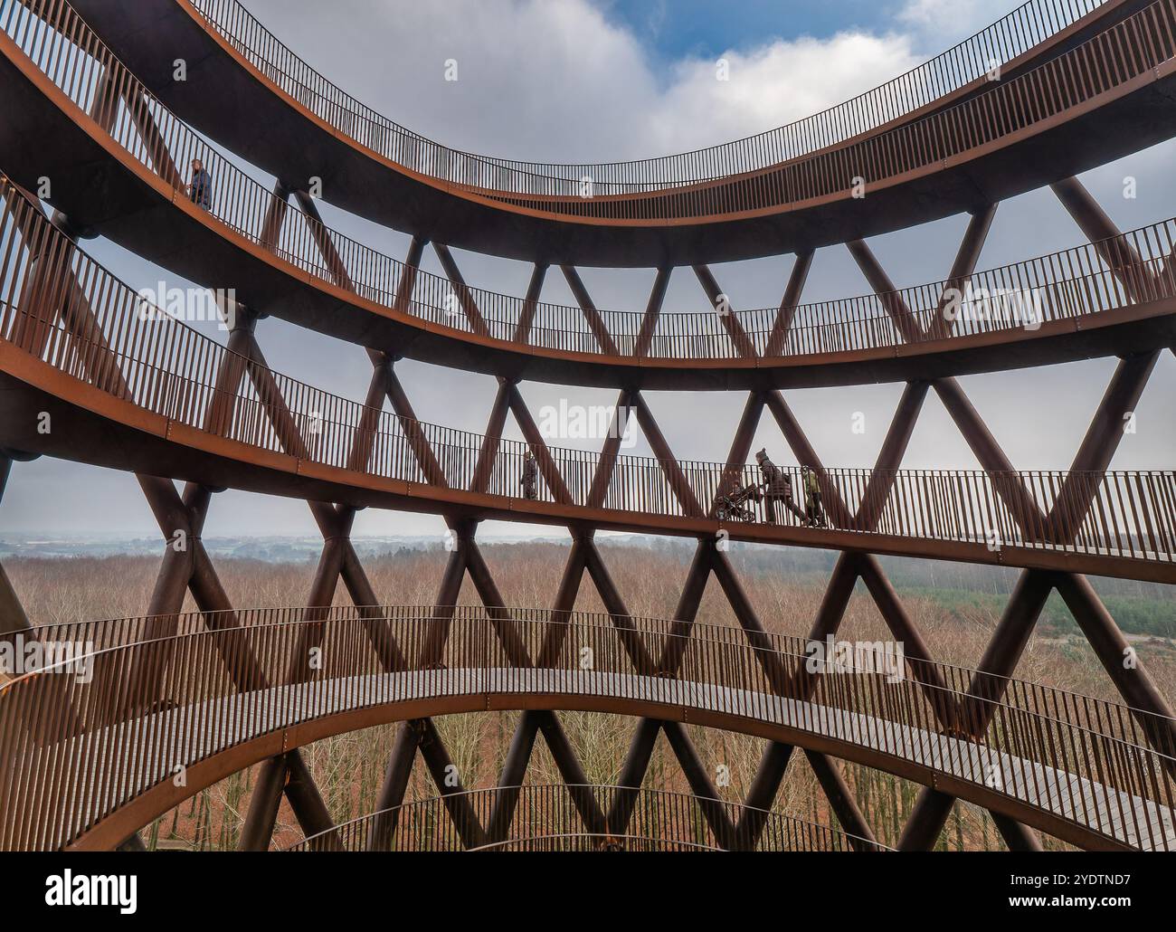 A striking spiral-shaped wooden observation tower set against a clear ...