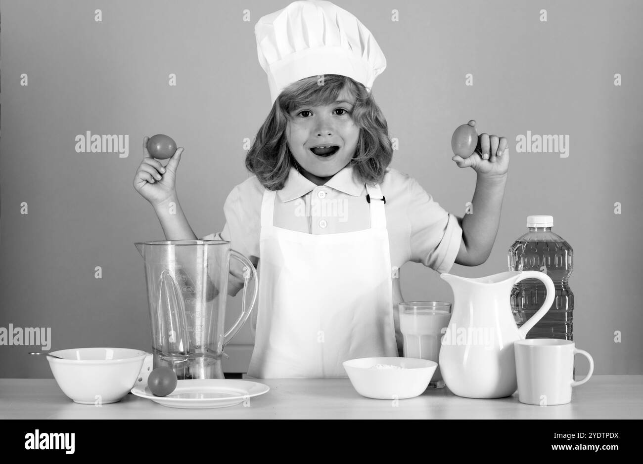 Portrait of chef child in cook hat hold eggs. Cooking at home, kid boy ...