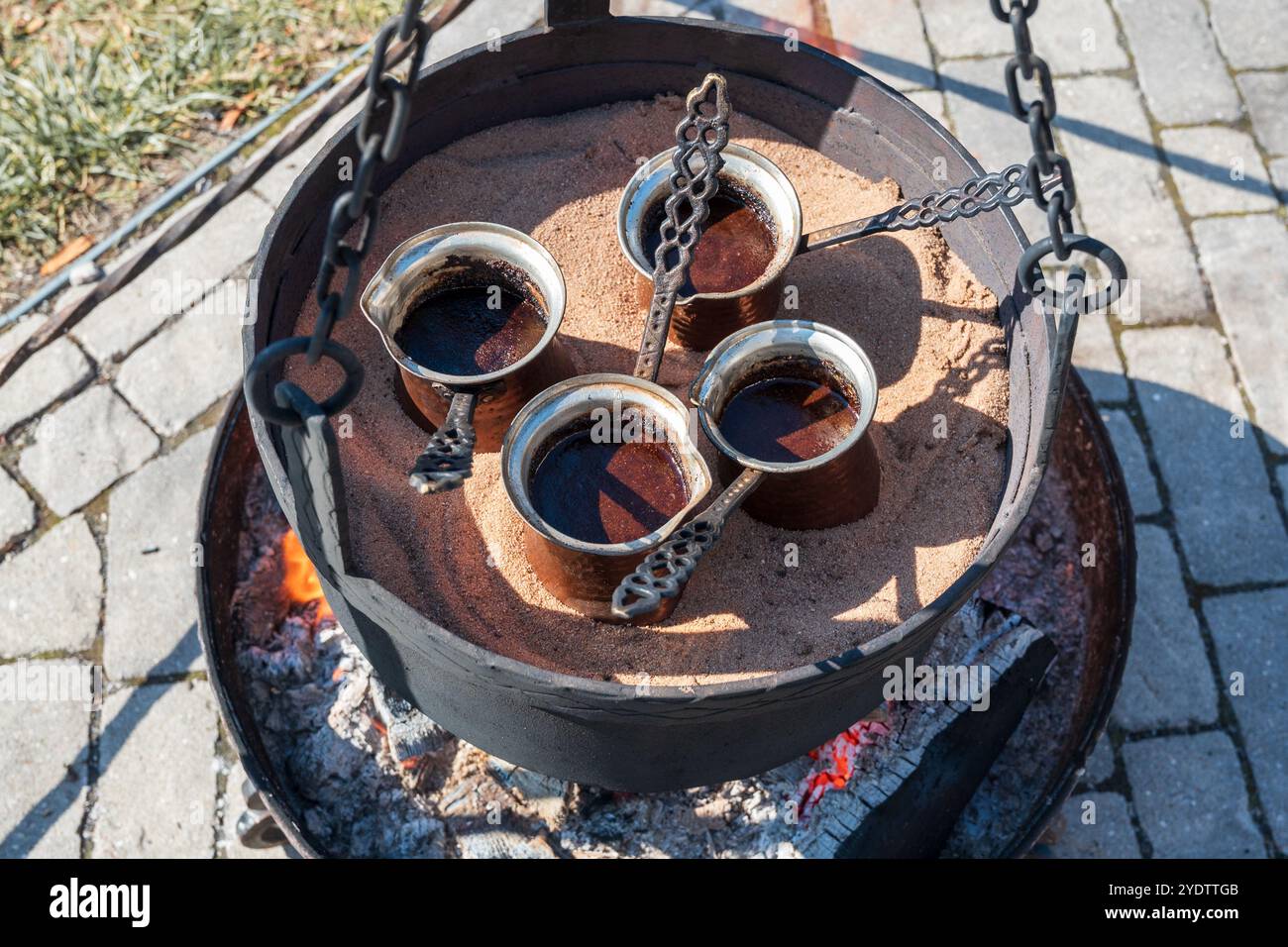 cooking turkish coffee in hot sand over open fire Stock Photo - Alamy