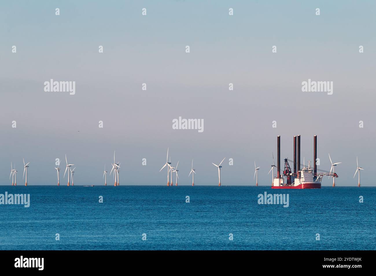 Jack up wind turbines installation vessel in the sea, with wind farm on ...