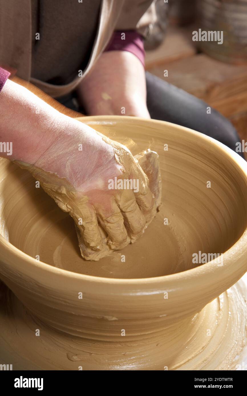 Potter turning a potter's wheel Stock Photo - Alamy