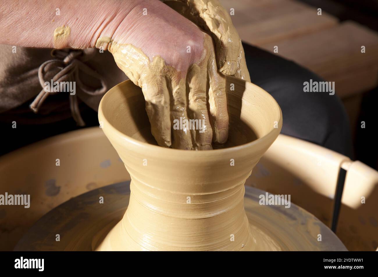 Potter turning a potter's wheel Stock Photo - Alamy