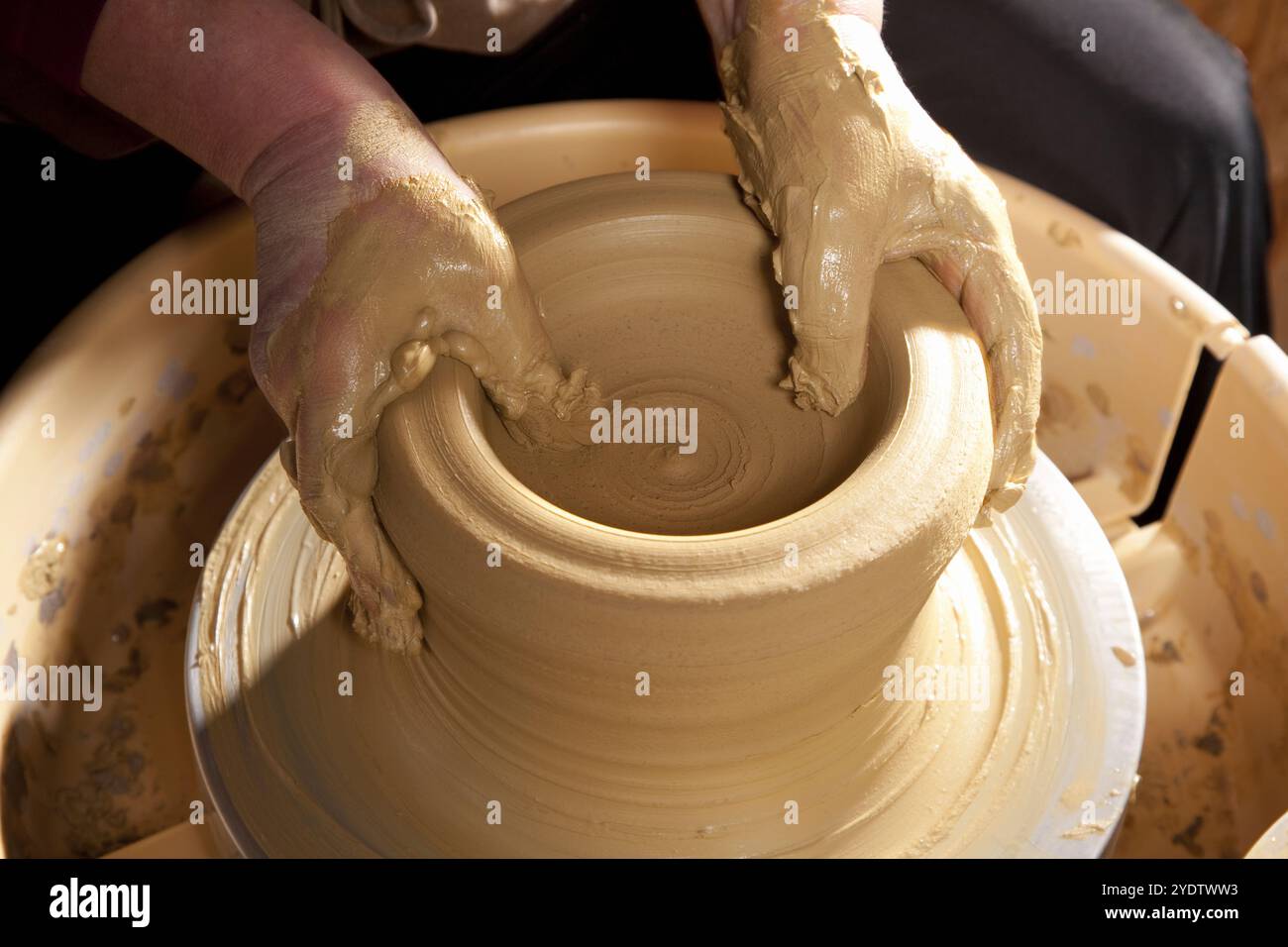 Potter turning a potter's wheel Stock Photo - Alamy