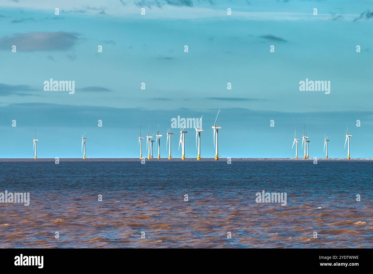 Wind turbine farm in the sea near the coastline. Green wind energy ...