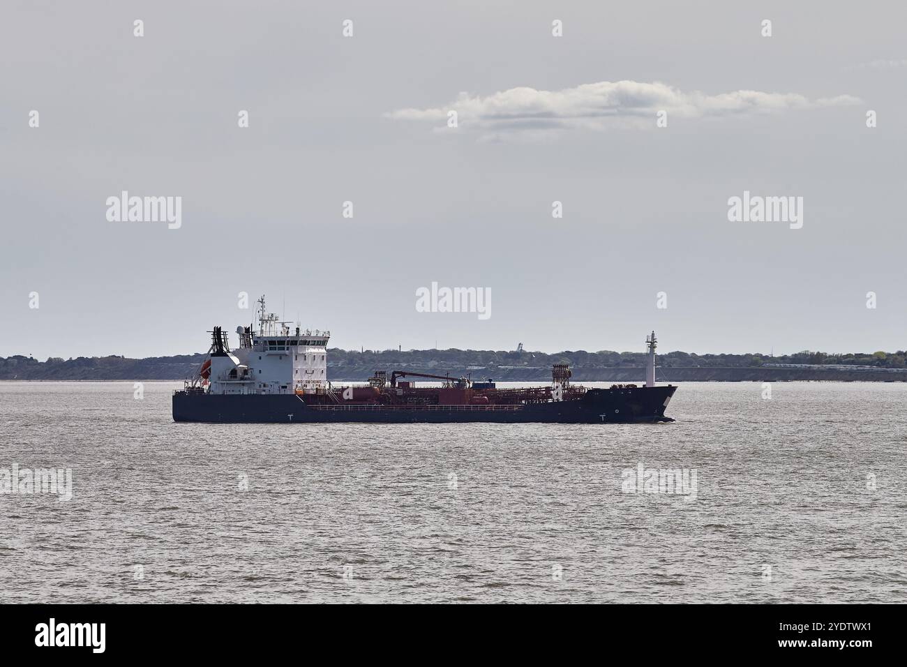 Small tanker vessel navigating in port on a clear day Stock Photo - Alamy