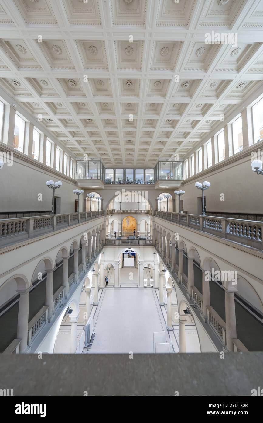Light-flooded, symmetrical building interior with corridors and columns ...