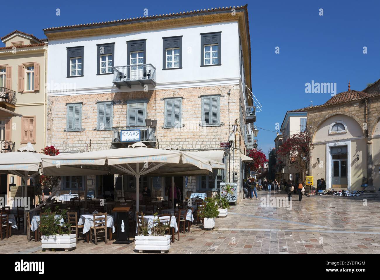 A square with a historic building, cafe with parasols and Mediterranean ...