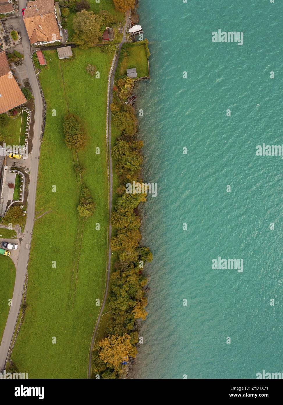 Aerial view of the lakeshore with green water and neighbouring ...