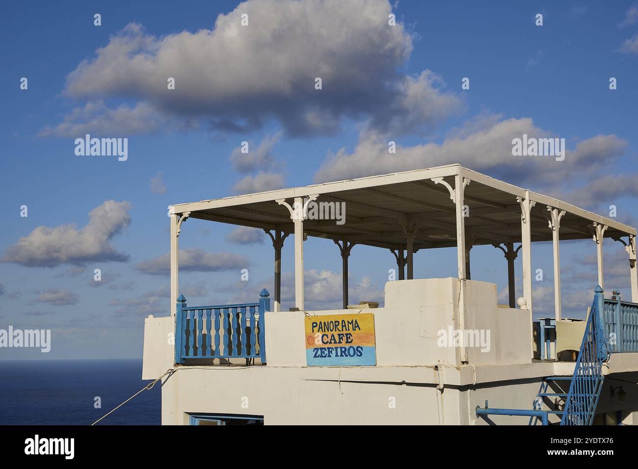 Coffee veranda with sea view and blue sky, equipped with blue railings ...