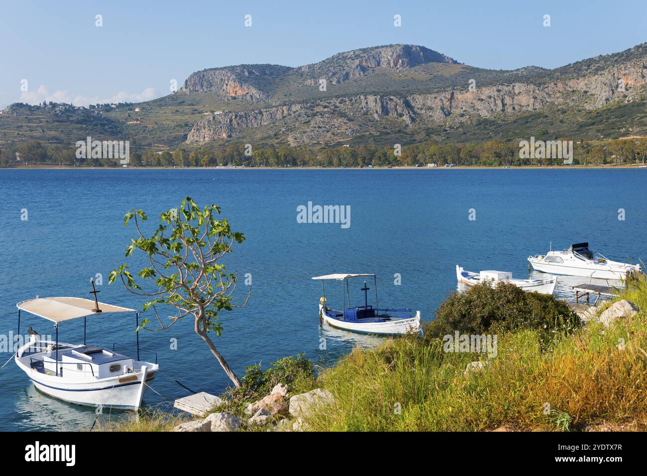 Sea view with several boats, surrounded by mountains in clear, sunny ...