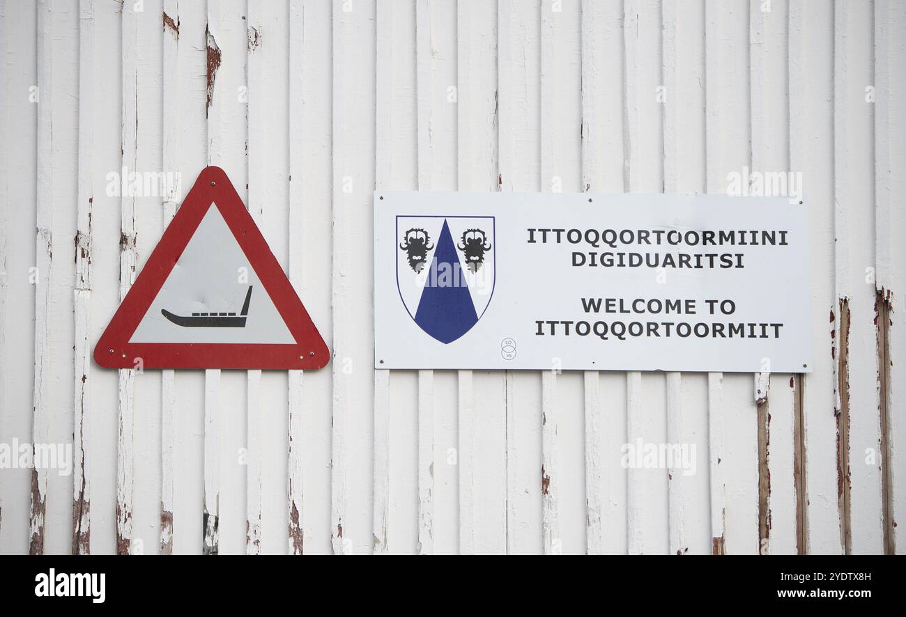 White wooden wall with a warning sign with a sledge symbol and a ...