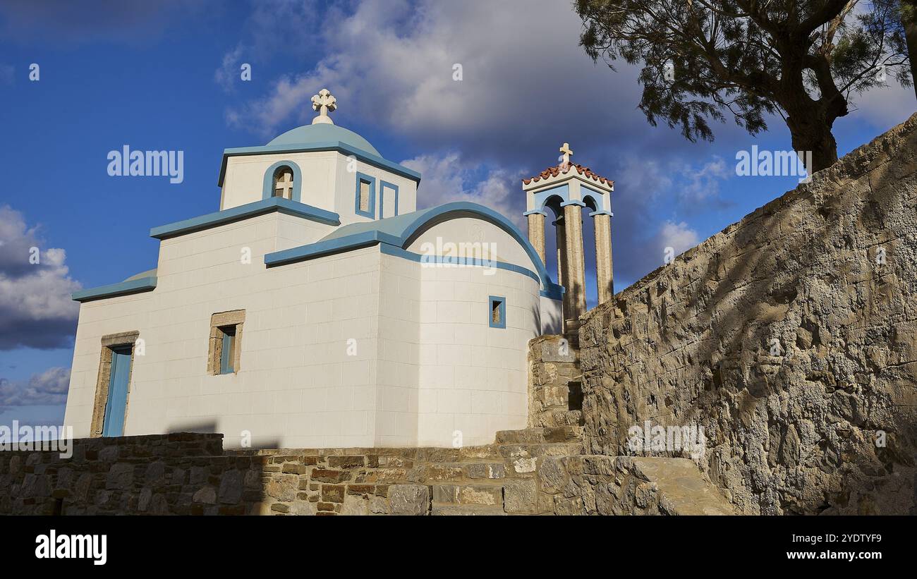 Saint Filimon Church, Greek church with blue domes and a tree under a ...
