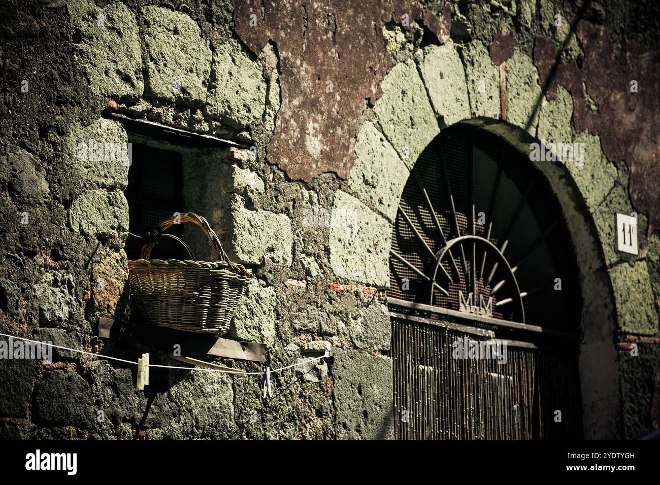 Wicker basket left to dry on an outside window of a vinery with tuff ...
