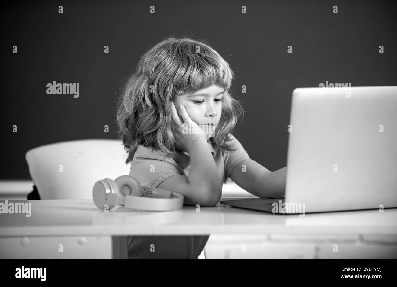 Child boy using a laptop computer at school. Education, school ...