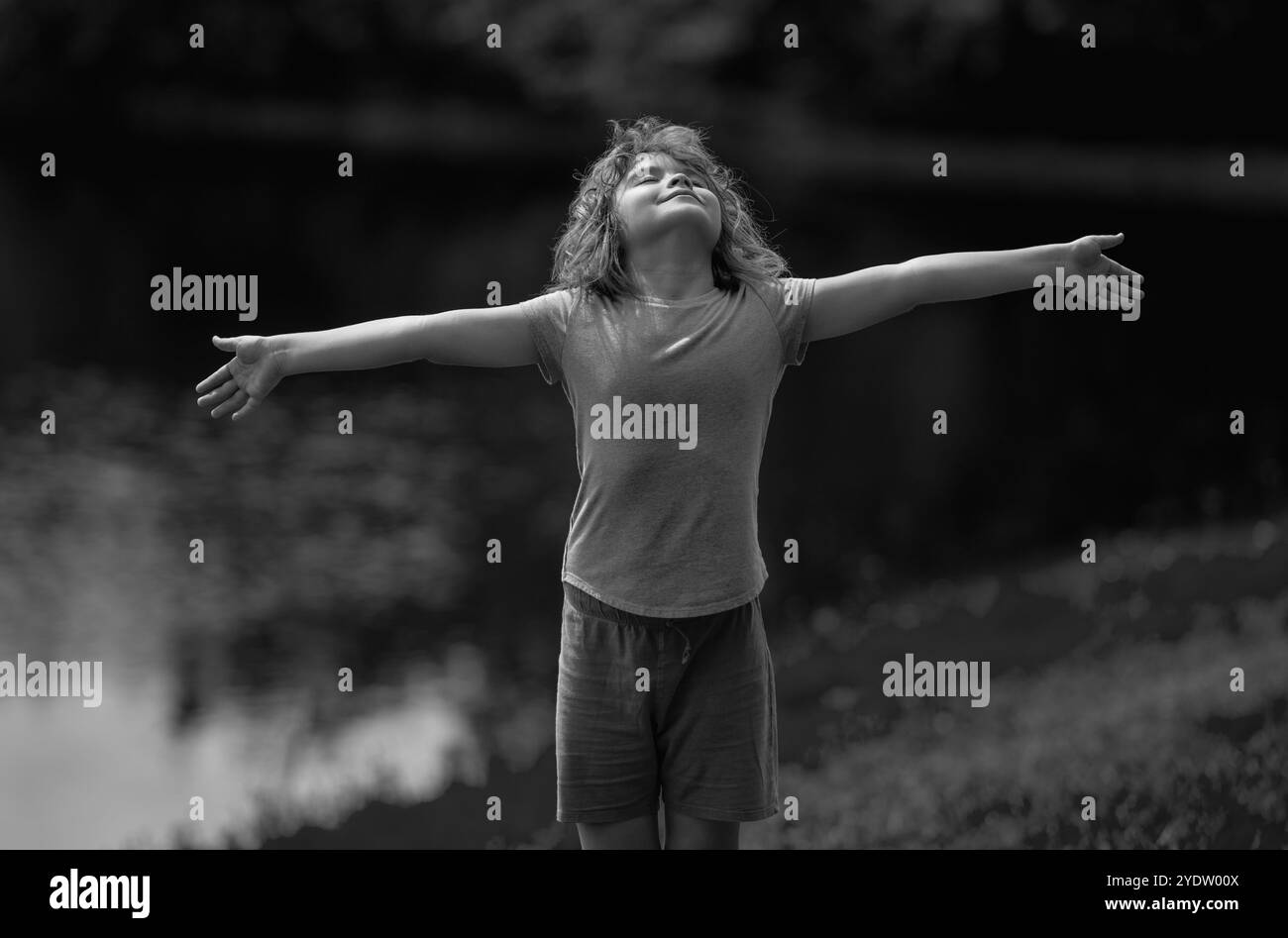 Happy kid with arms up enjoying freedom in nature. Child open arms ...