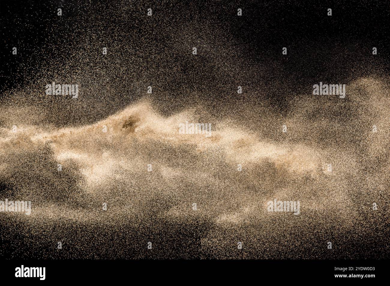 Dry river sand explosion. Golden colored sand splash against black ...
