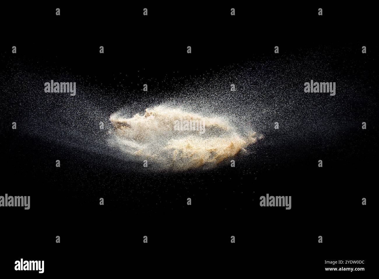 Sand explosion isolated on black background. Freeze motion of sandy ...