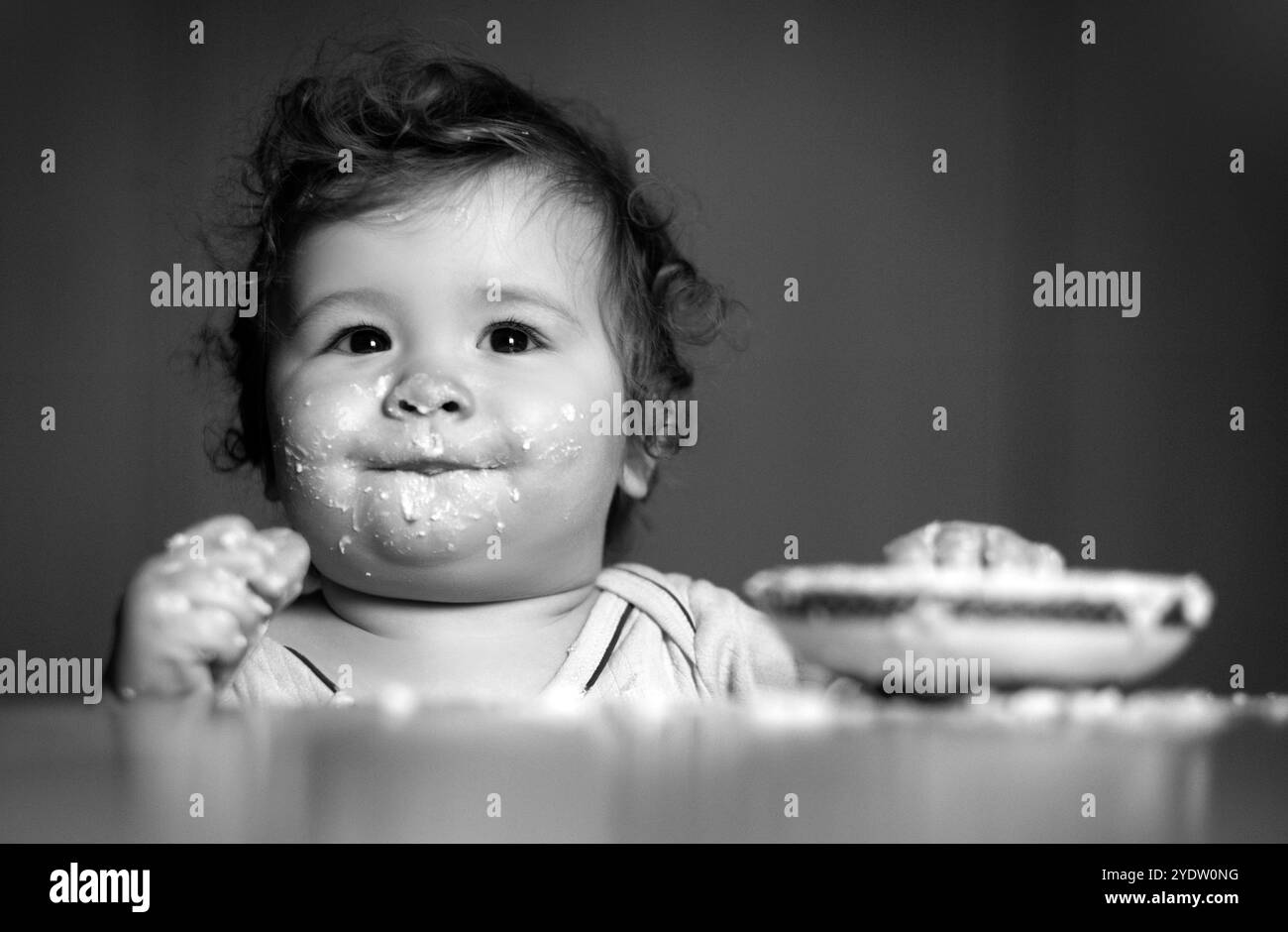 Happy child eating delicious dessert Black and White Stock Photos ...