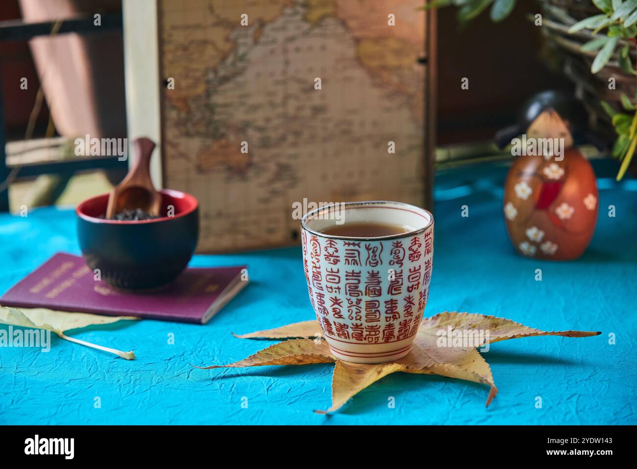 Tea served in a typical cup with Japanese ideograms, in the background ...