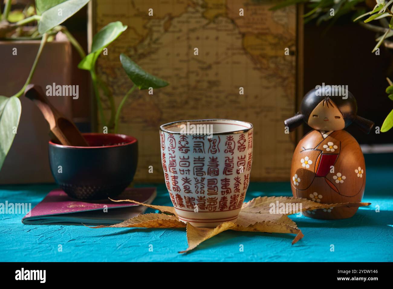Tea served in a typical cup with Japanese ideograms, in the background ...