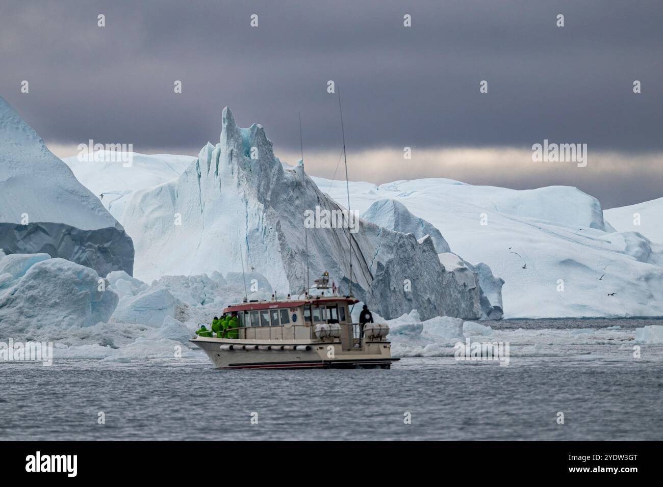 Little boat between the icebergs of the Ilulissat Icefjord, UNESCO ...