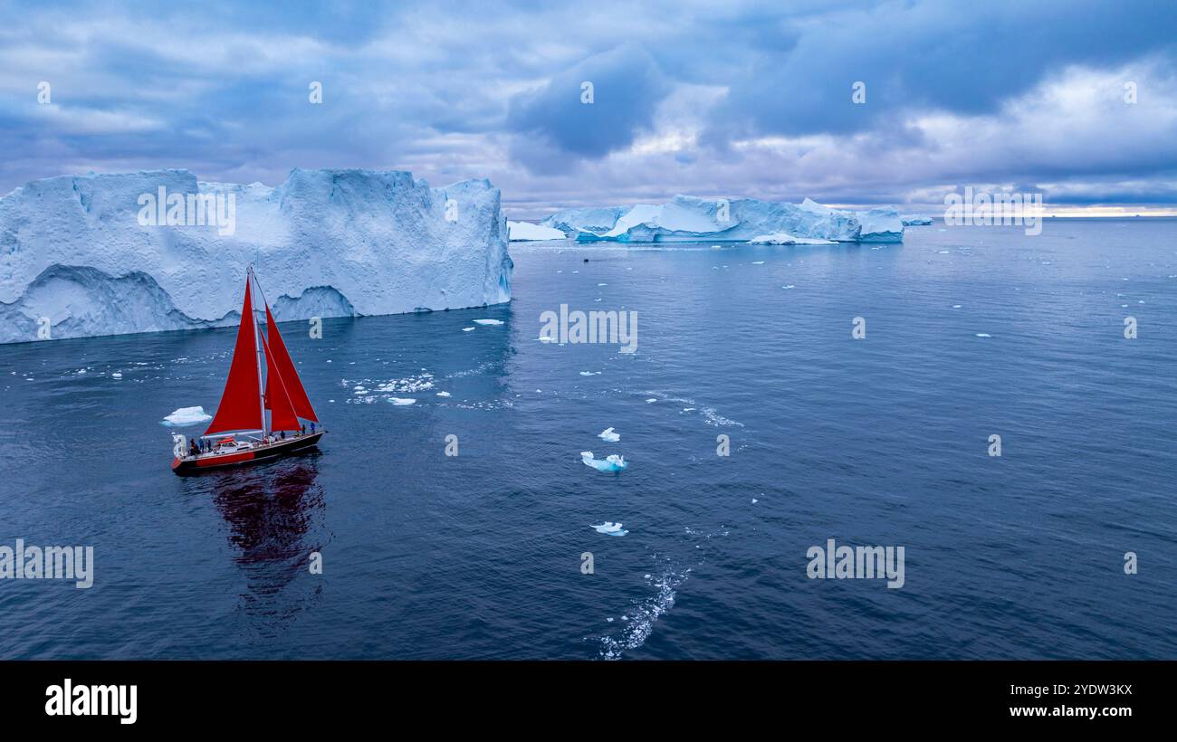 Aerial of a red sailing boat in the Ilulissat Icefjord, UNESCO World ...