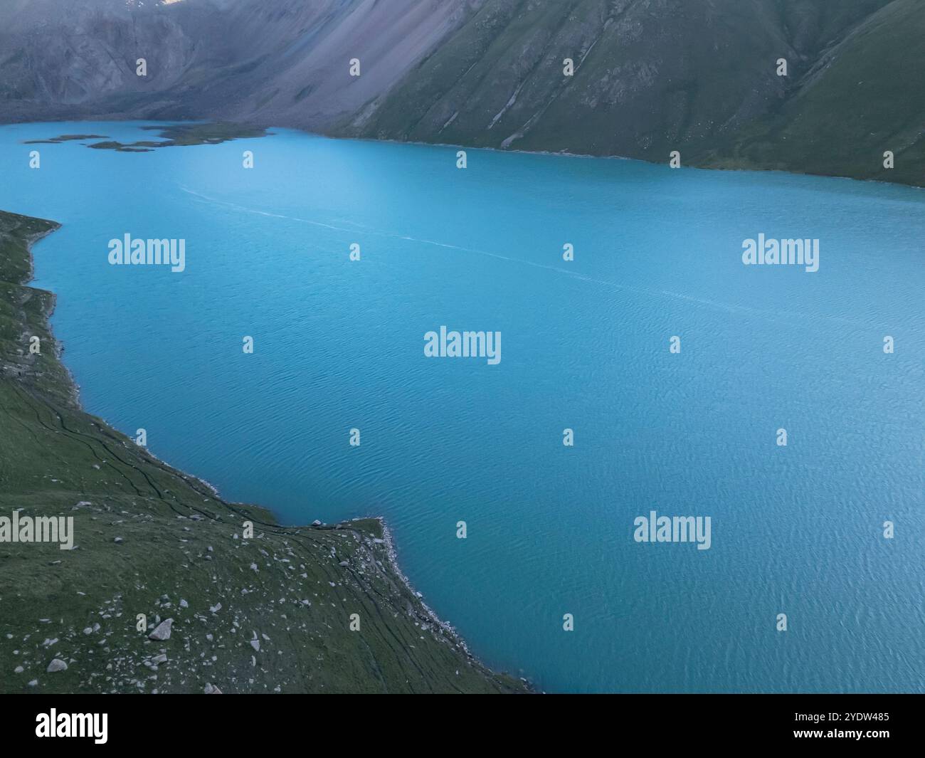 Kol-Ukok Mountain Lake surrounded by green mountains under a blue sky ...