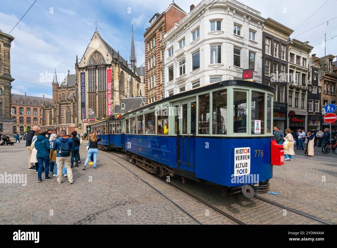 Blue tram and The New Church (De Nieuwe Kerk) in background at Dam ...