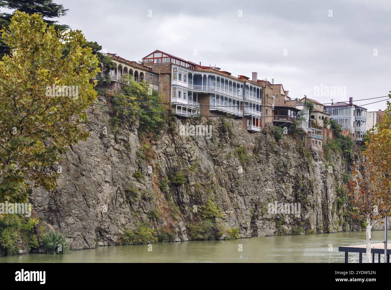 Houses with balconies on a cliff above the Kura River, Tbilisi, Georgia ...