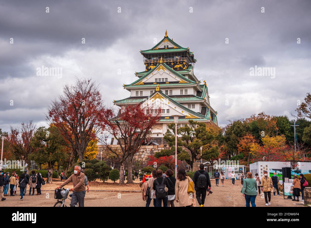 Osaka Castle in autumn with visitors in front, Osaka, Honshu, Japan ...