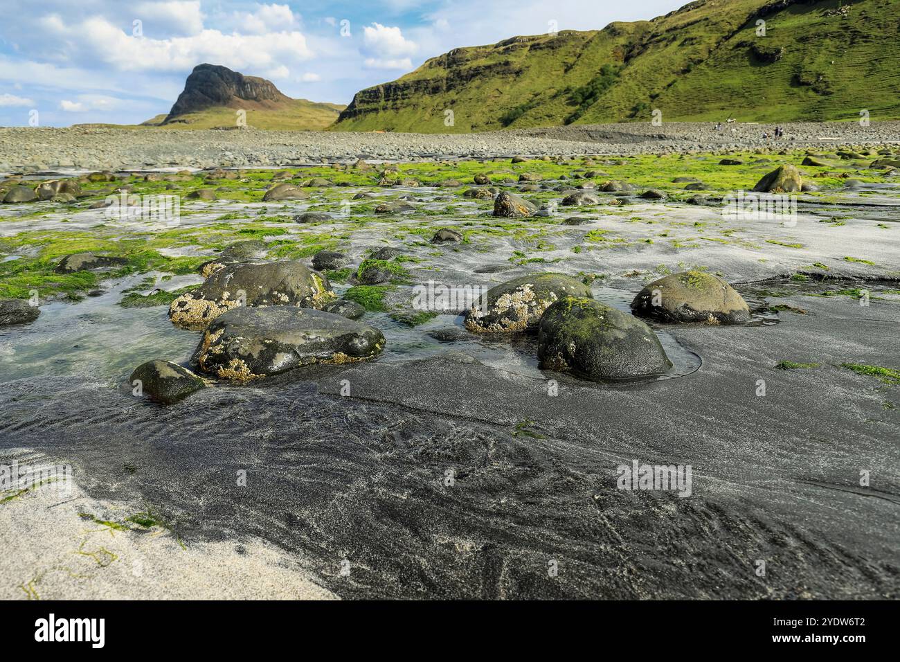 The white and black sand beach and estuary at Talisker with Preshal ...