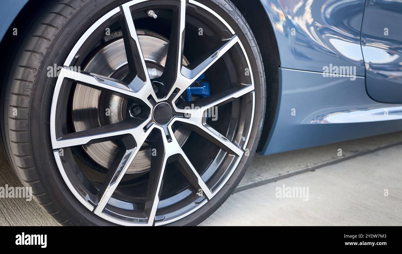 Car detailing closeup alloy wheel with tires and blue calipers side ...