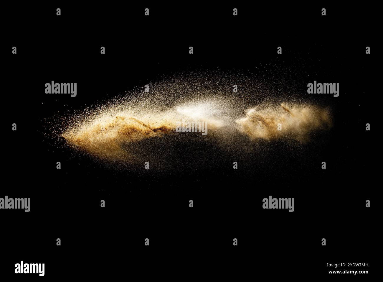 Sand flying explosion isolated on black background. Freeze motion of ...