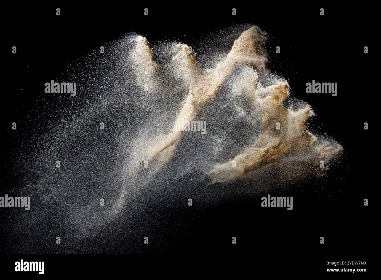 Sand flying explosion isolated on black background. Freeze motion of ...
