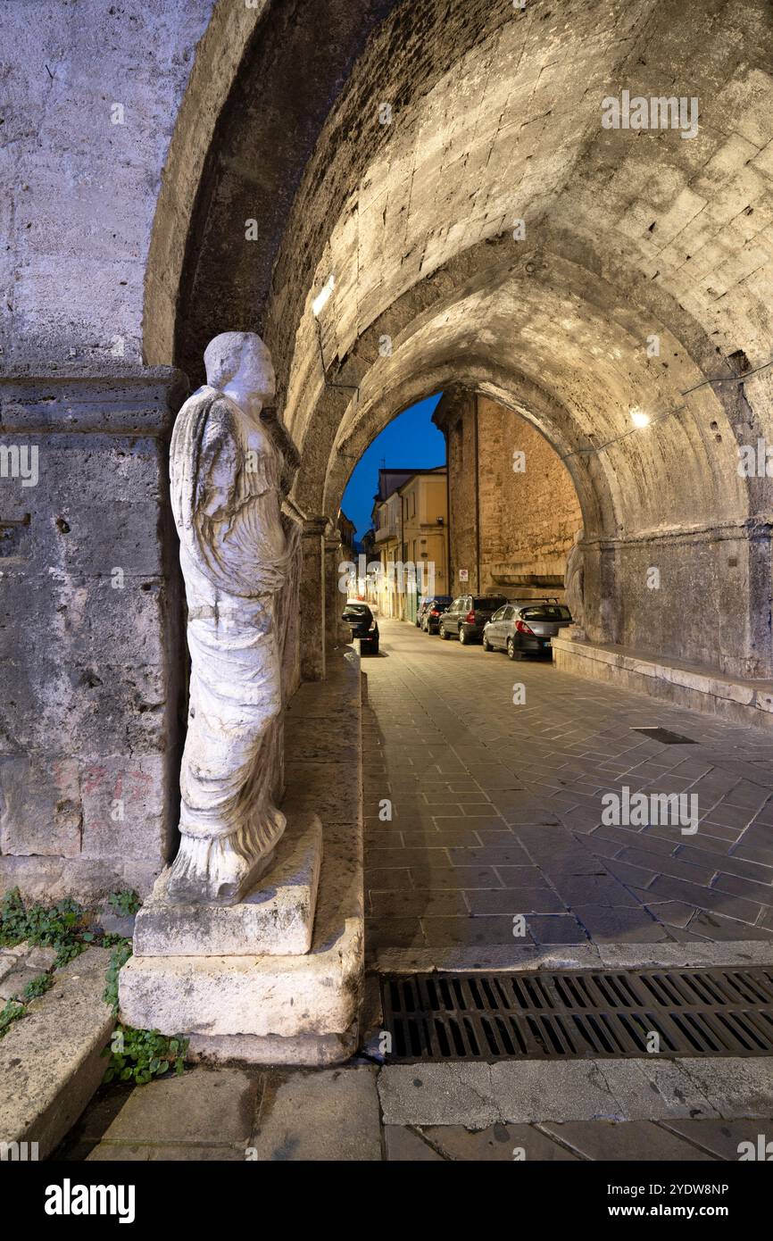 Roman toga-wearing statue from the forum area, Bell tower and arch of ...