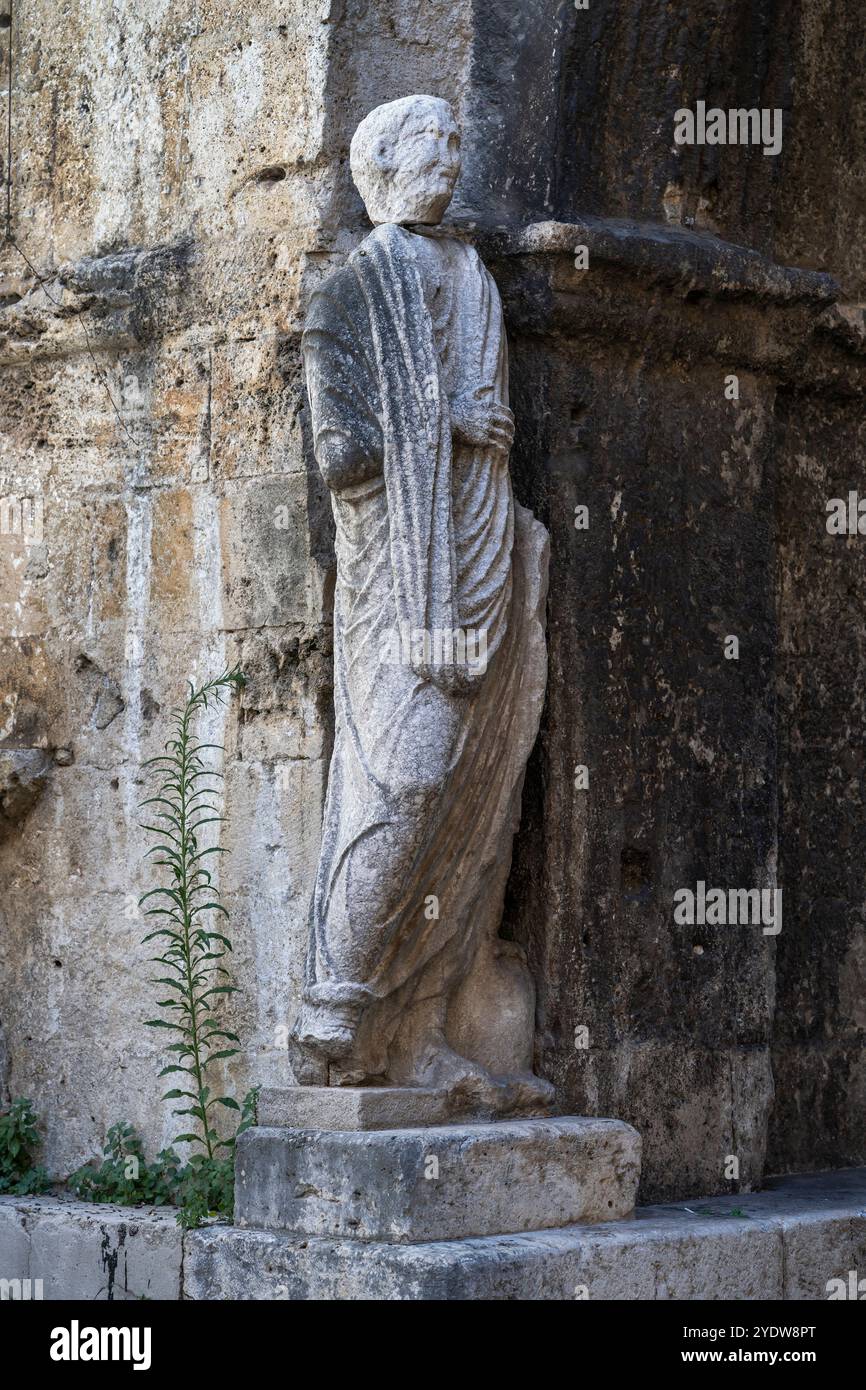 Roman toga-wearing statue from the forum area, Bell tower and arch of ...