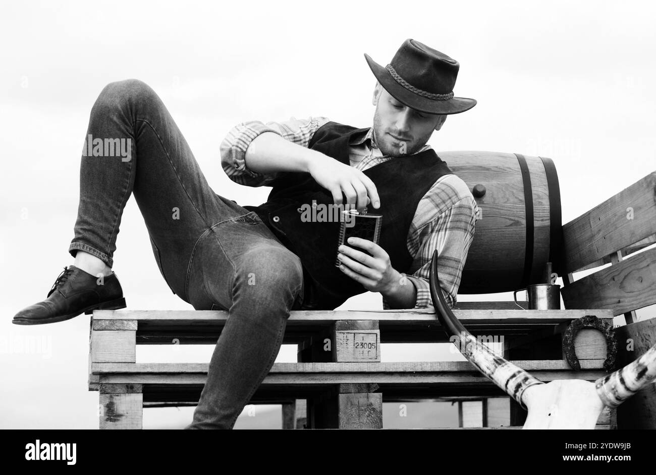 Cowboy drinking whiskey Black and White Stock Photos & Images - Alamy