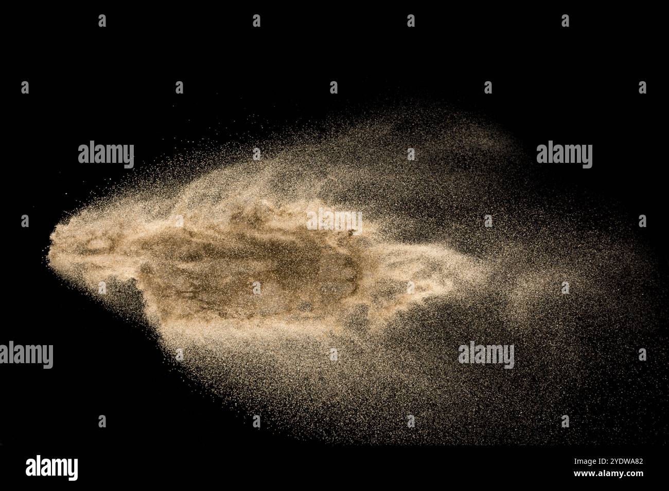 Dry river sand explosion. Golden colored sand splash against black ...