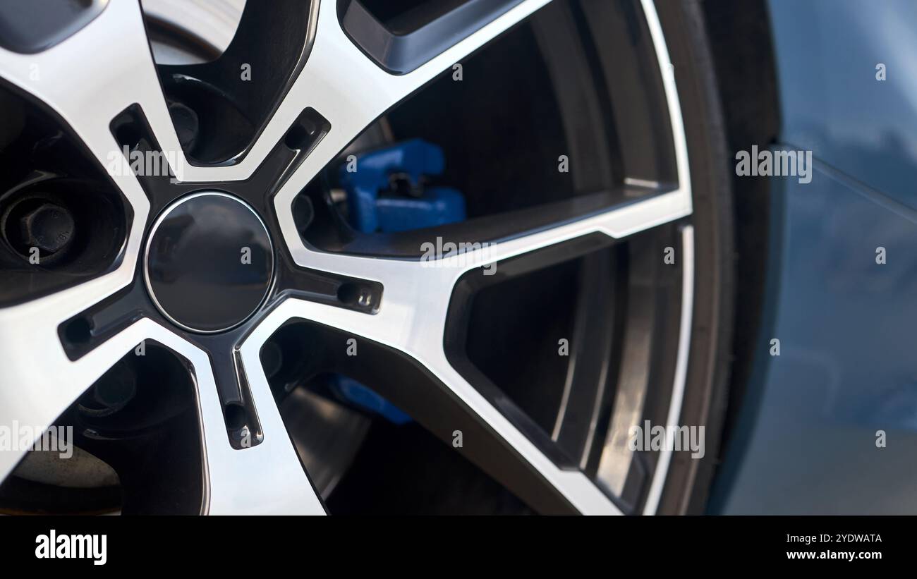 Car detailing closeup alloy wheel with tires and blue calipers side ...