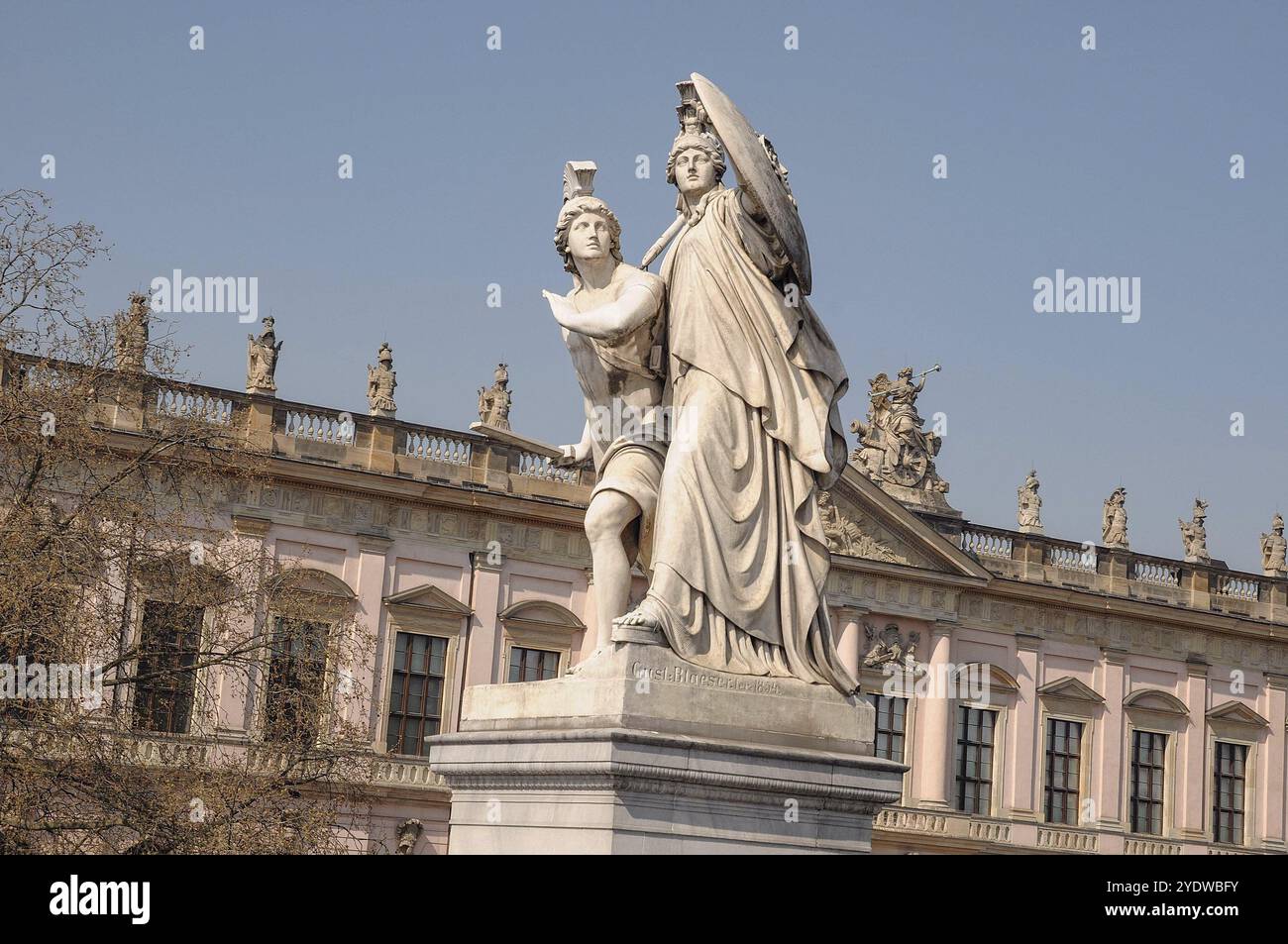 Classical sculpture of two figures in front of a historic building ...