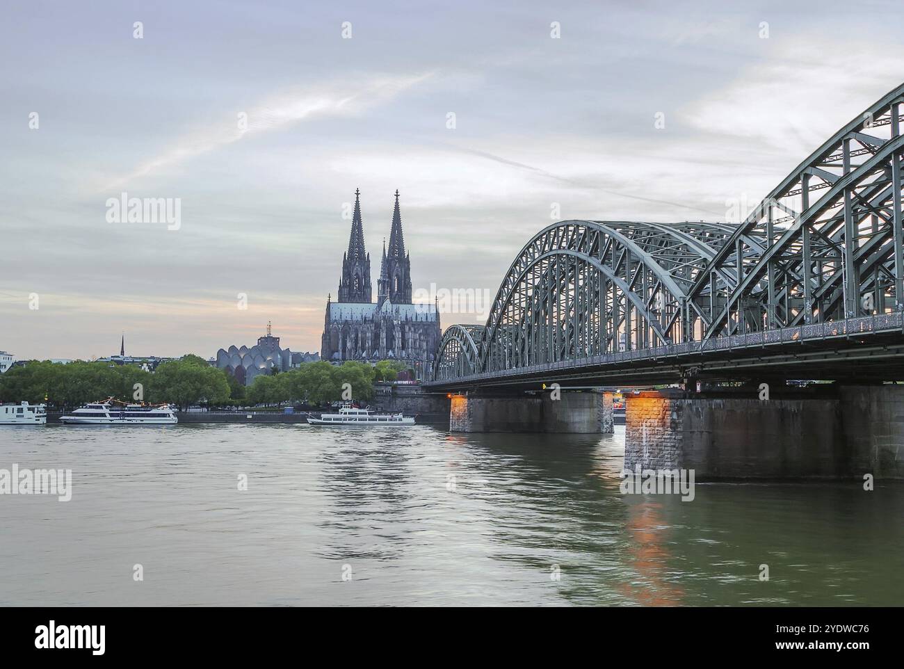 View of Cologne Cathedral with Hohenzollern Bridge in evening, Germany ...