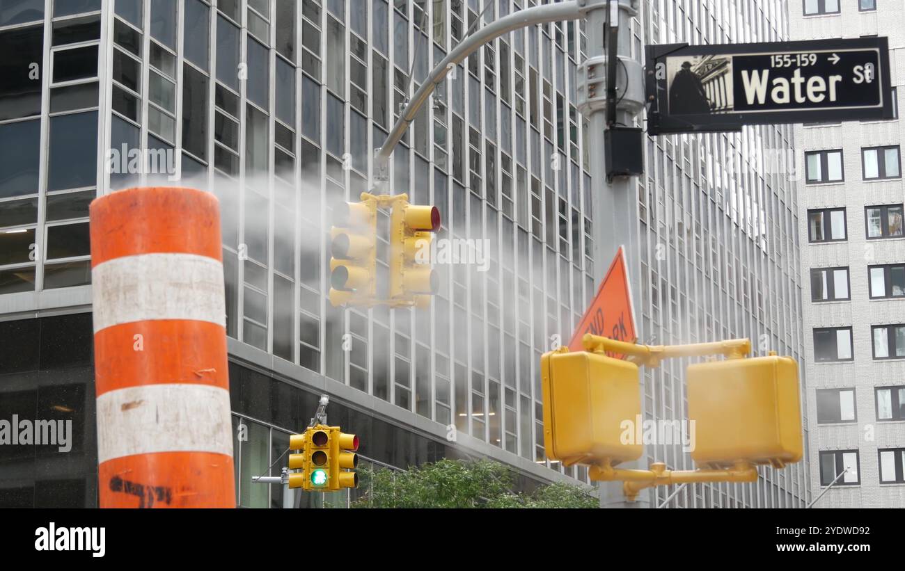 Steam vapor vented on New York City Water street, orange vapour tube ...