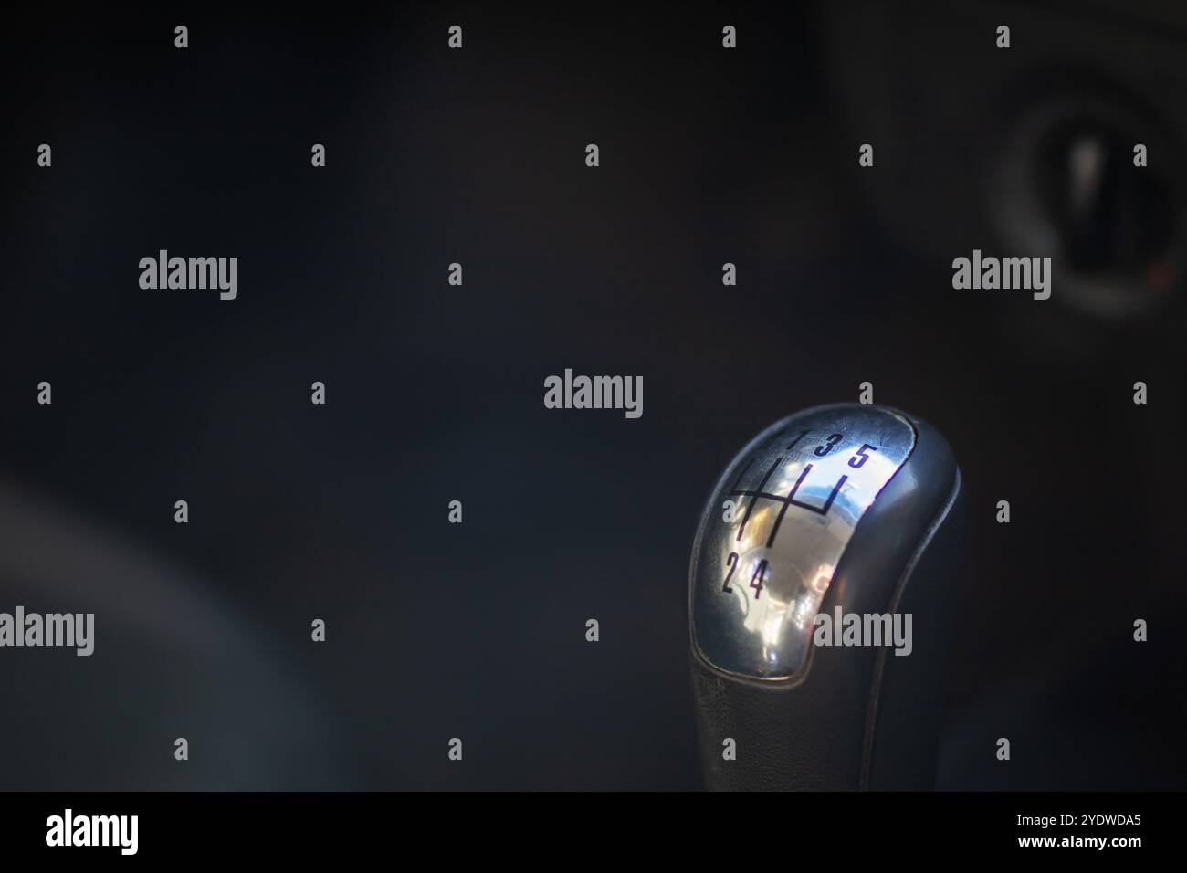 This image captures an intense closeup photograph of a car shifter ...